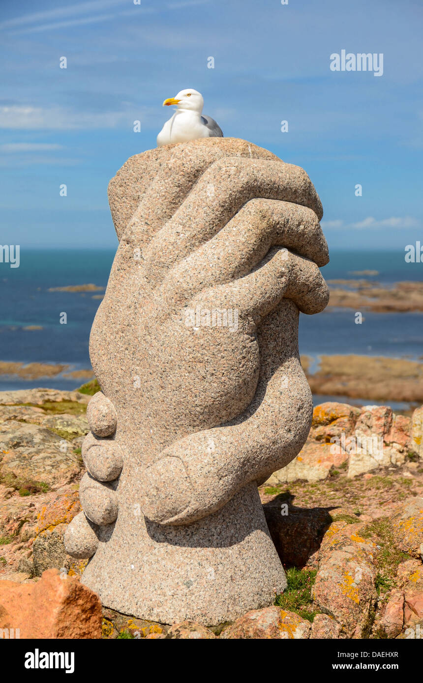 Seagull sitting on hand monument in Jersey, UK Stock Photo - Alamy