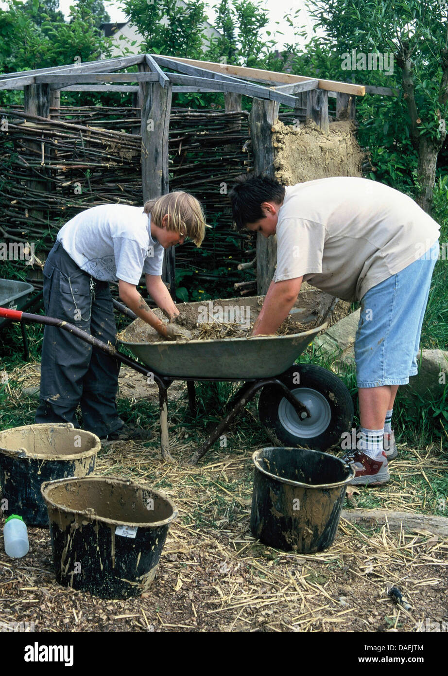 two boys building a clay hut in the garden, Germany Stock Photo - Alamy