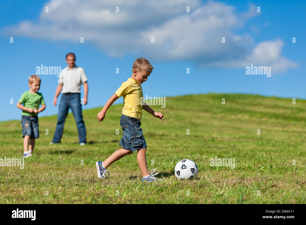 Happy family is playing soccer in summer in a beautiful landscape Stock ...