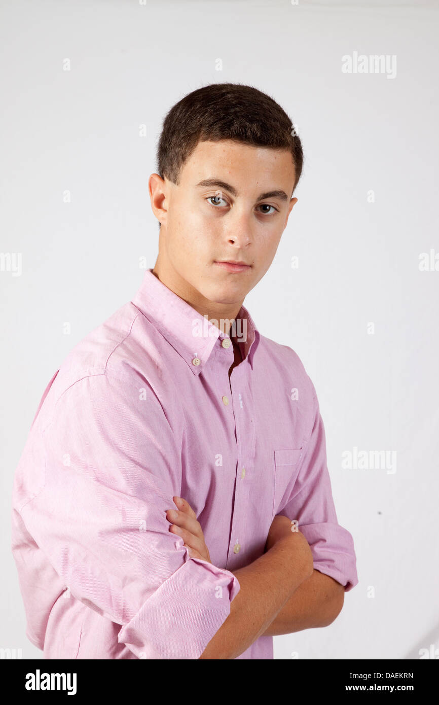 Handsome man standing with arms folded, looking thoughtfully at the ... Handsome man standing with arms folded, looking thoughtfully at the ...