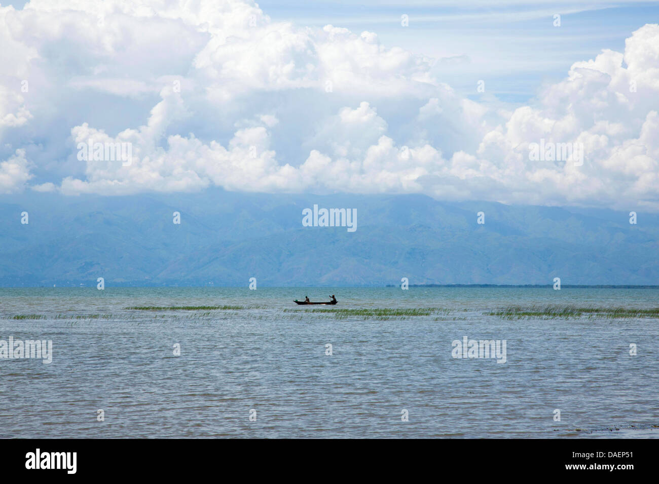 fishing boat on Lake Tanganyika and cloud-covered mountains, Burundi ...