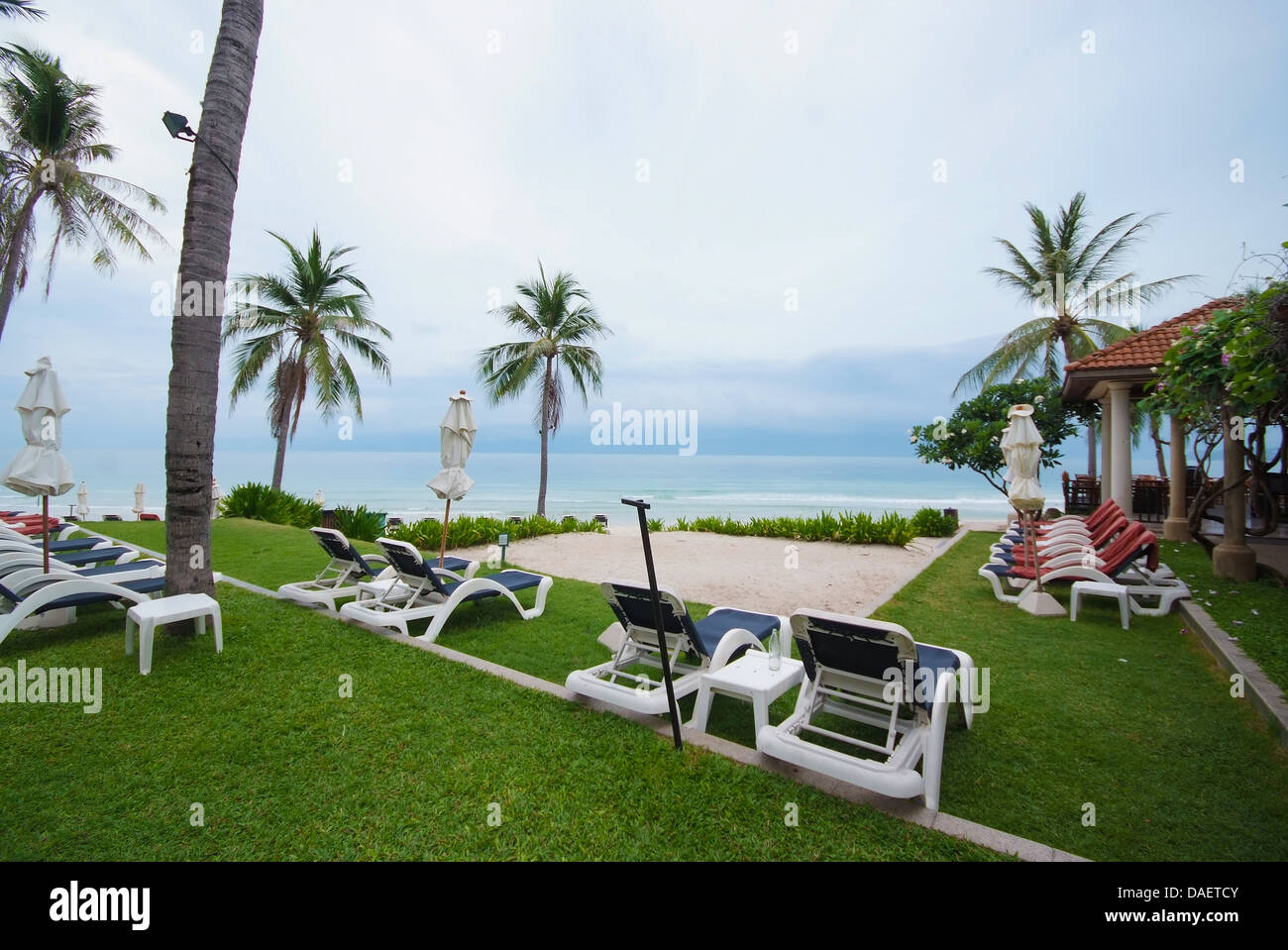 Swimming pool beside the sea with coconut tree modern luxury hotel ...