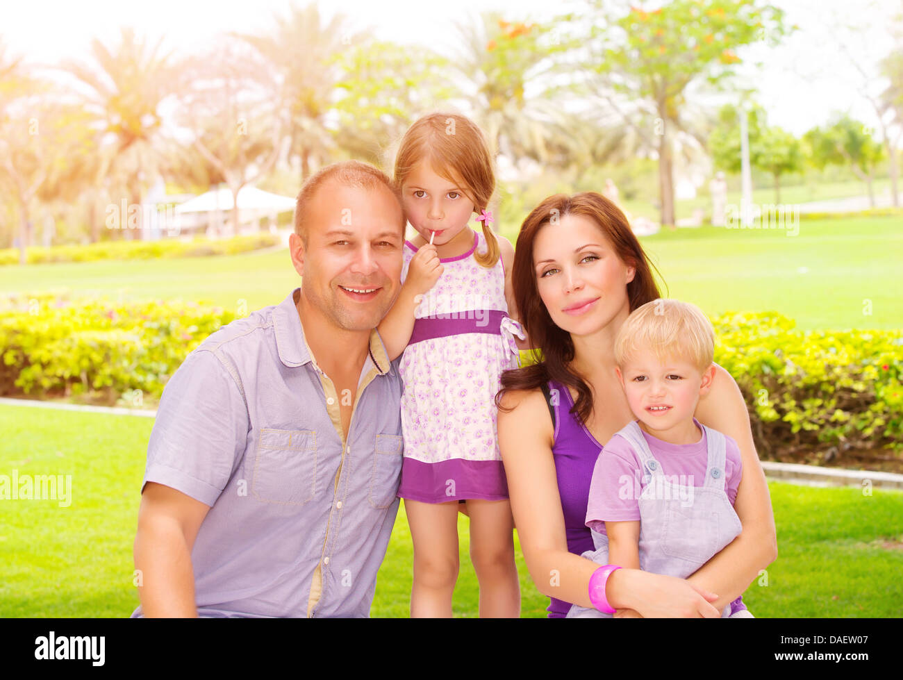 Portrait of cute family in spending time together in the park, happy ...