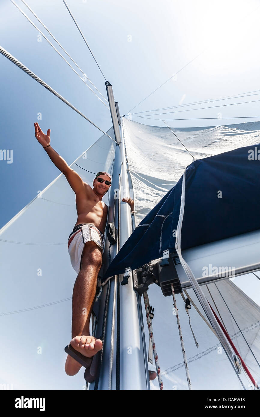 Young cheerful skipper on the yacht, strong handsome sailor on vessel ...