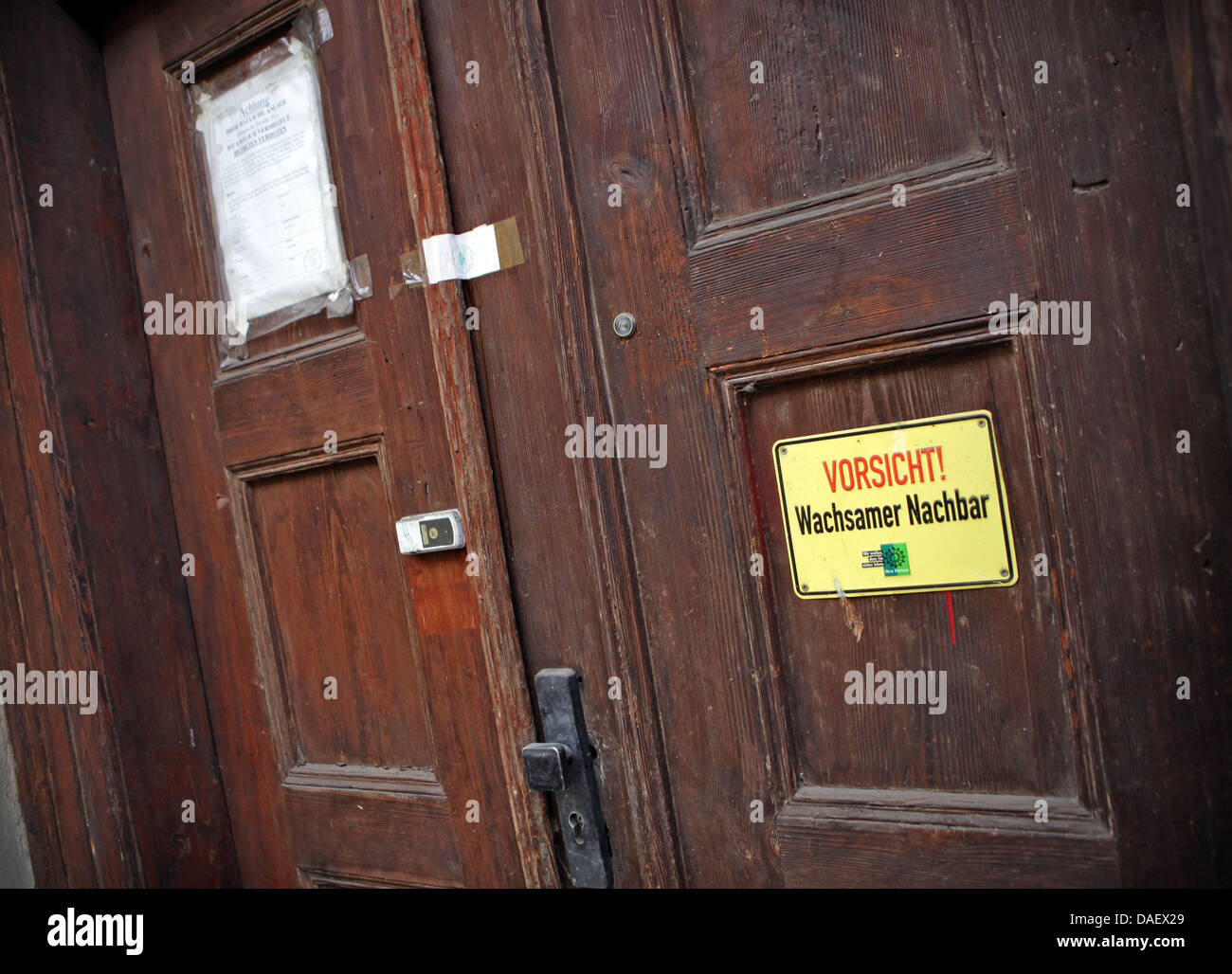 "Beware! Observant Neighbor" is read on the sign on the sealed door of ...
