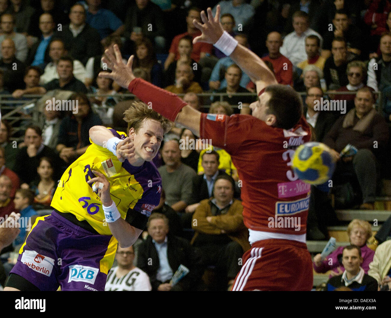 Berlin's Sven Soeren Christophersen (L) scores a goal during the EHF ...