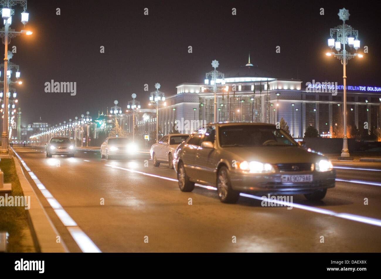 Cars drive past modern buildings in the governmental quarter of ...