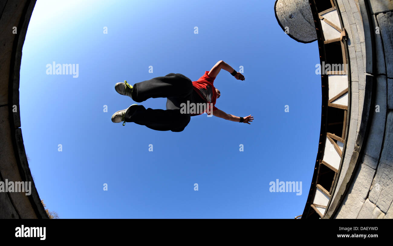 A traceur jumps from wall to wall in Hanover, Germany, 21 November 2011 ...