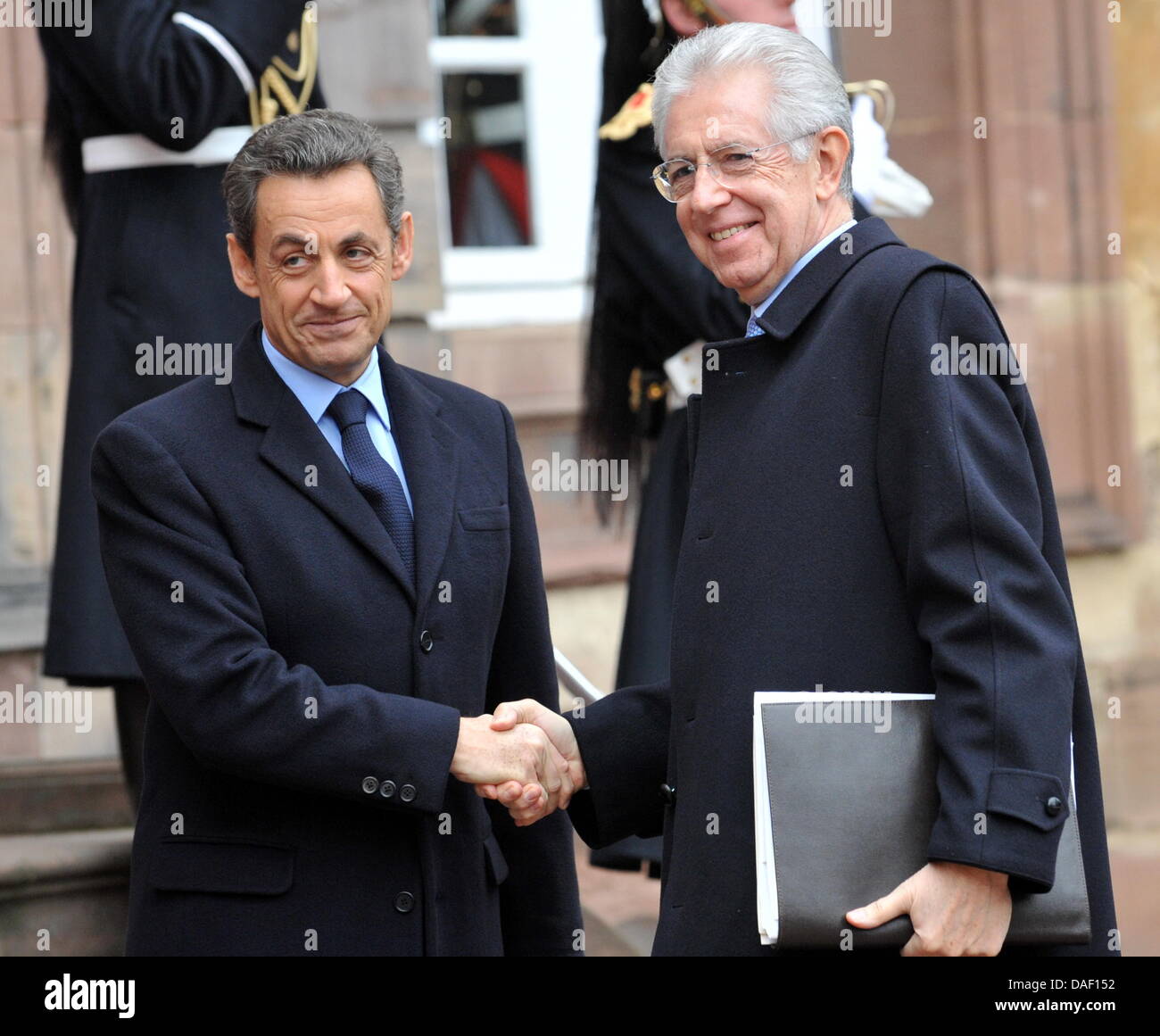 French President Nicolas Sarkozy (L) shakes hands with Italian Prime ...