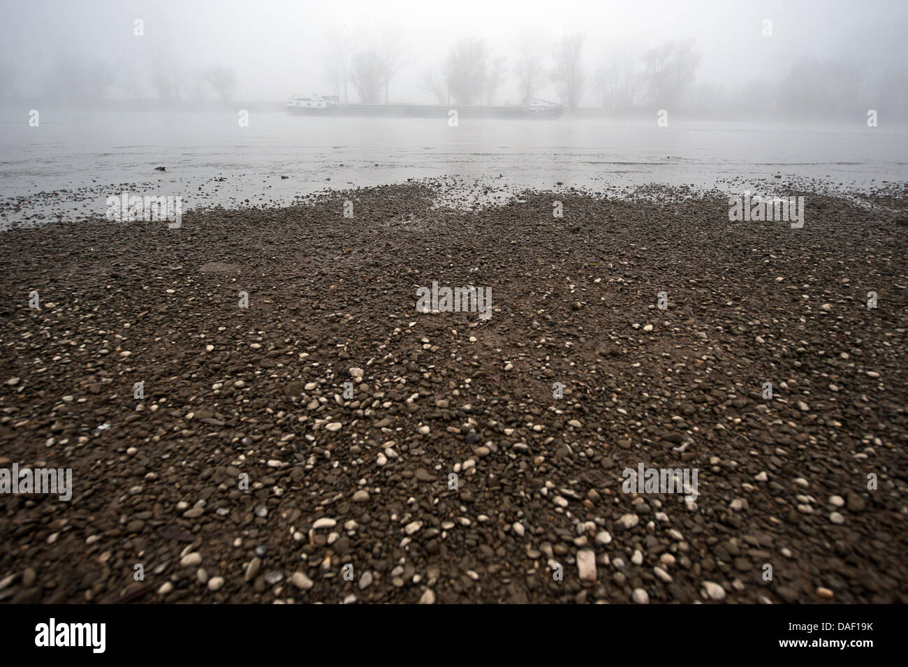 A river barge travels on the low tide waters of the River Danube near ...