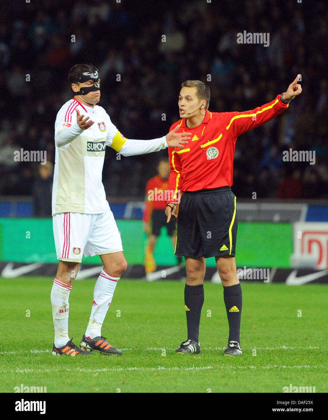Referee Robert Hartmann (R) reprimands Leverkusen's Michael Ballack ...