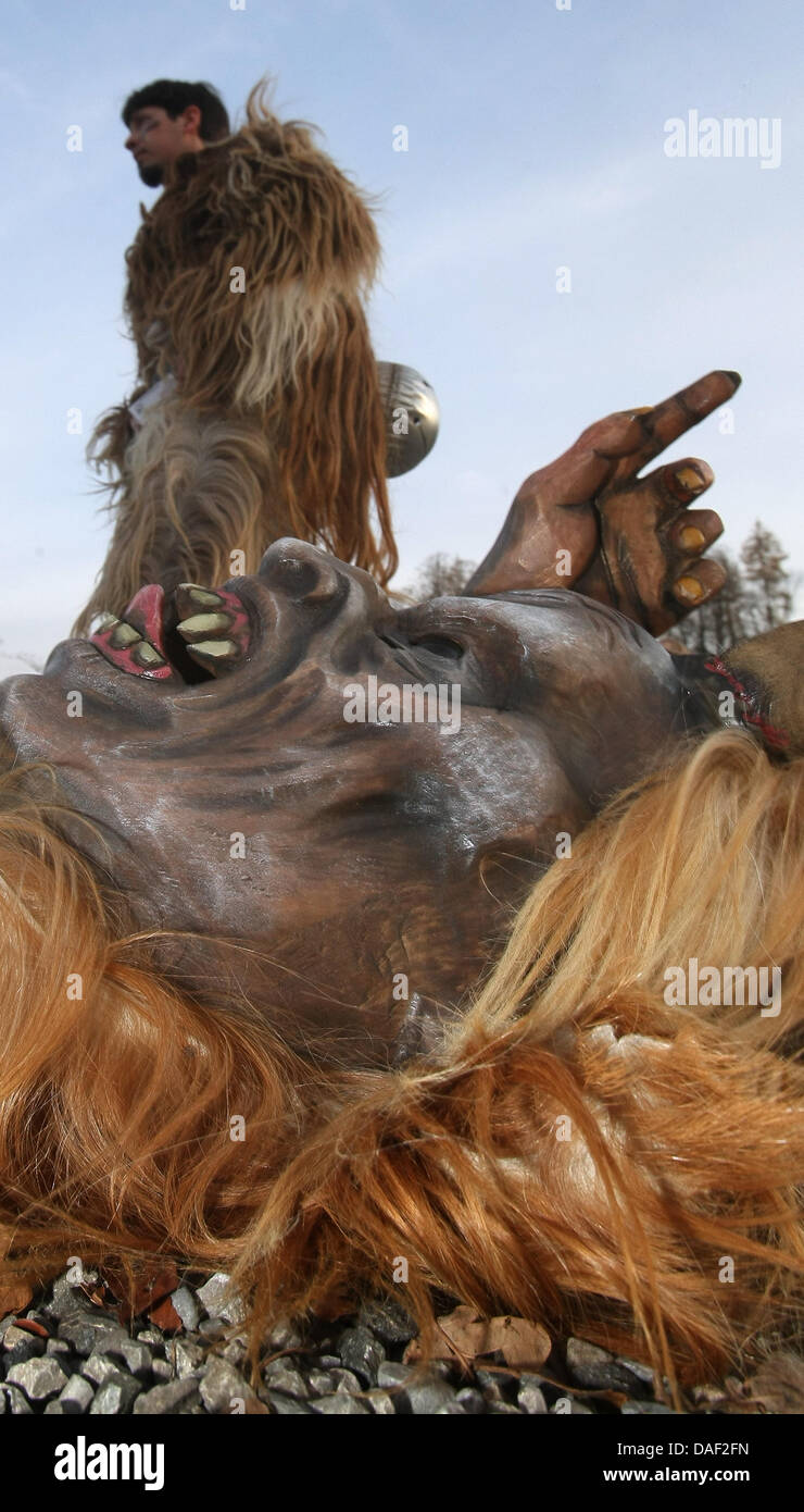 A young man stands next to his winter fools costume, also known as ...