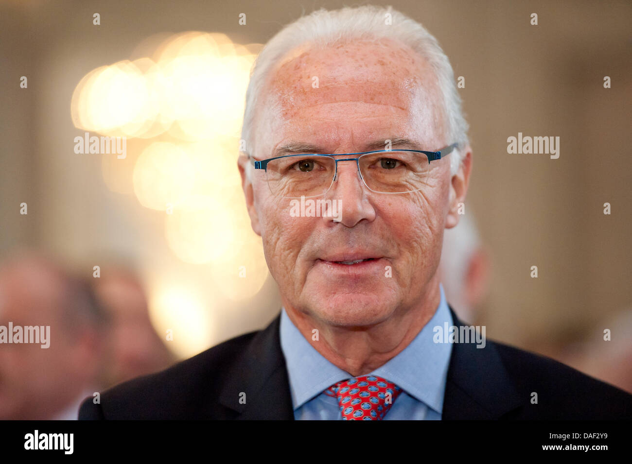 German former soccer player Franz Beckenbauer smiles after receiving ...