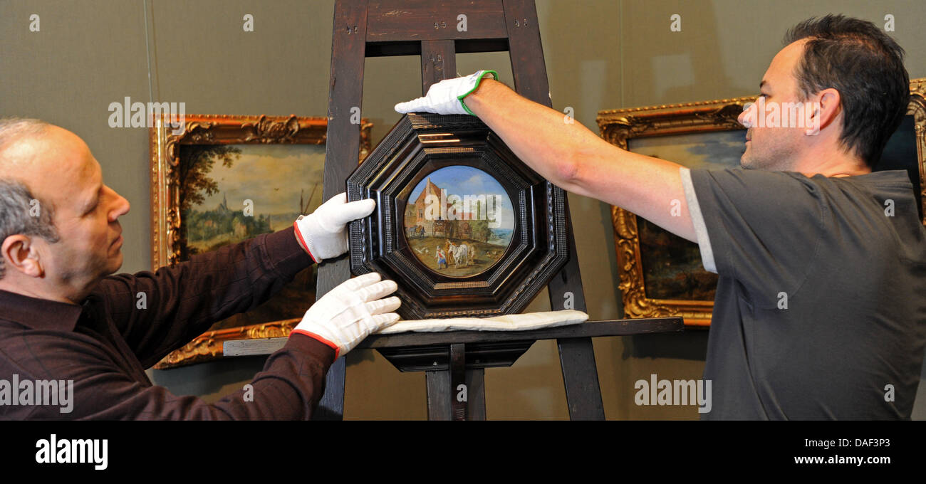 Adam Kalinowski (L) and Michael Schweiger (R) attach the circular ...
