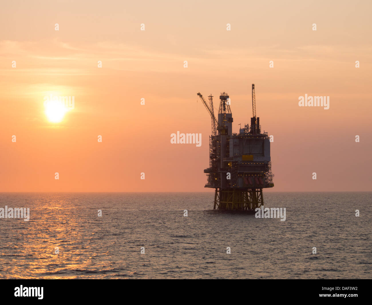 Sunrise at an offshore oil platform on the North Sea, in the Norwegian ...