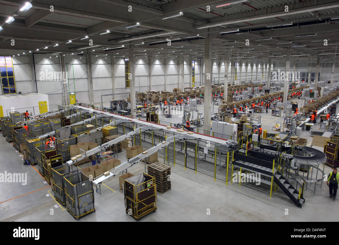 Amazon employeess work inside the online seller's new logistics centre ...