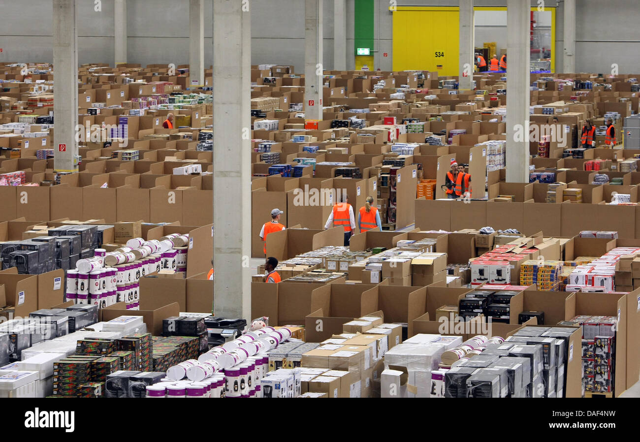 Amazon employeess work inside the online seller's new logistics centre ...