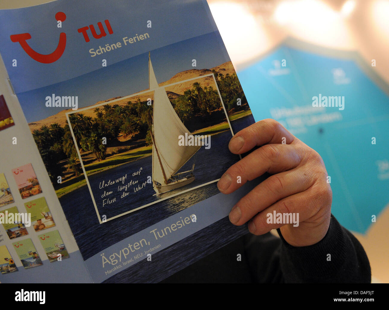 A TUI shareholder skims through an Egypt travel catalogue at the TUI ...