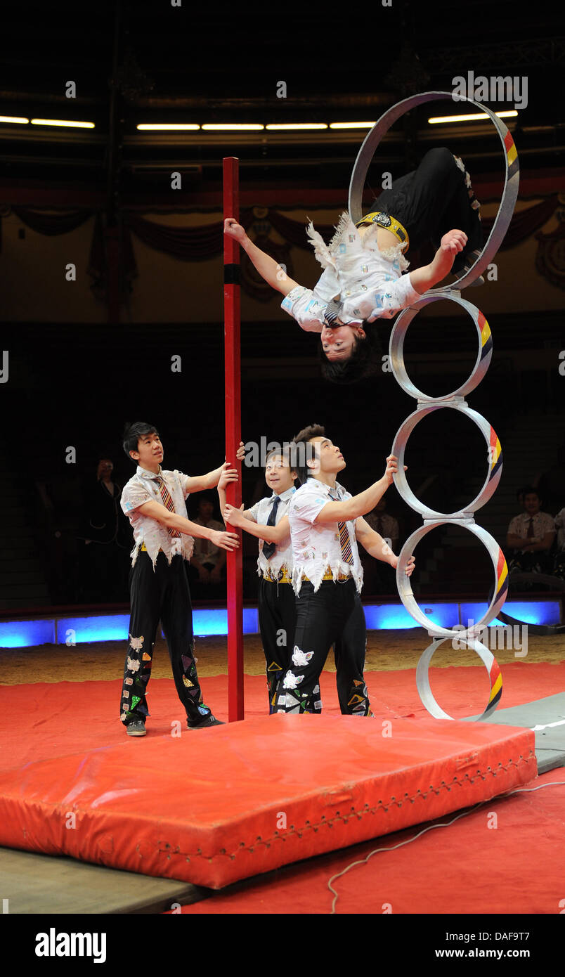 The 18-year-old Chinese artistic performer Qu Hao jumps through a hoop ...