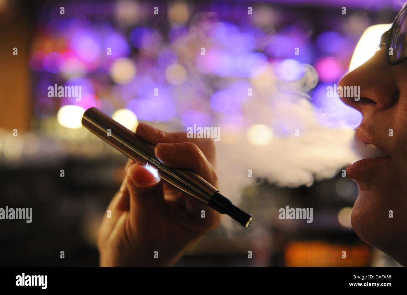 A woman smokes an electrical cigarette in Hamburg, Germany, 26 January ...