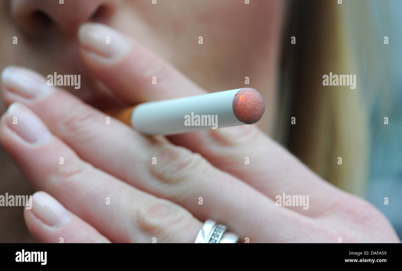 A woman smokes an electrical cigarette in Hamburg, Germany, 26 January ...