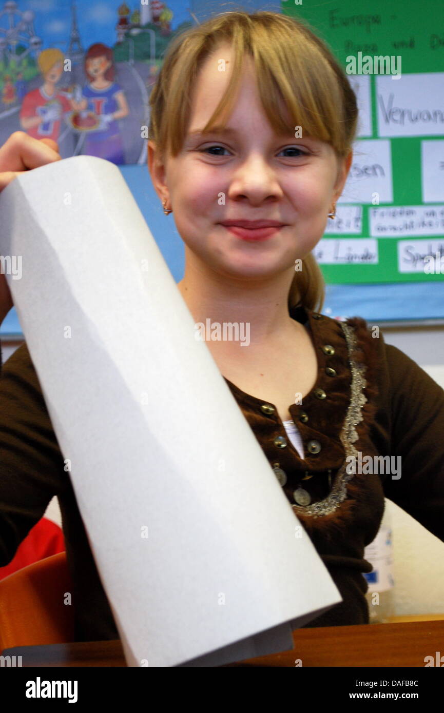 A schoolgirl proudly presents her paper model of the leaning tower of ...