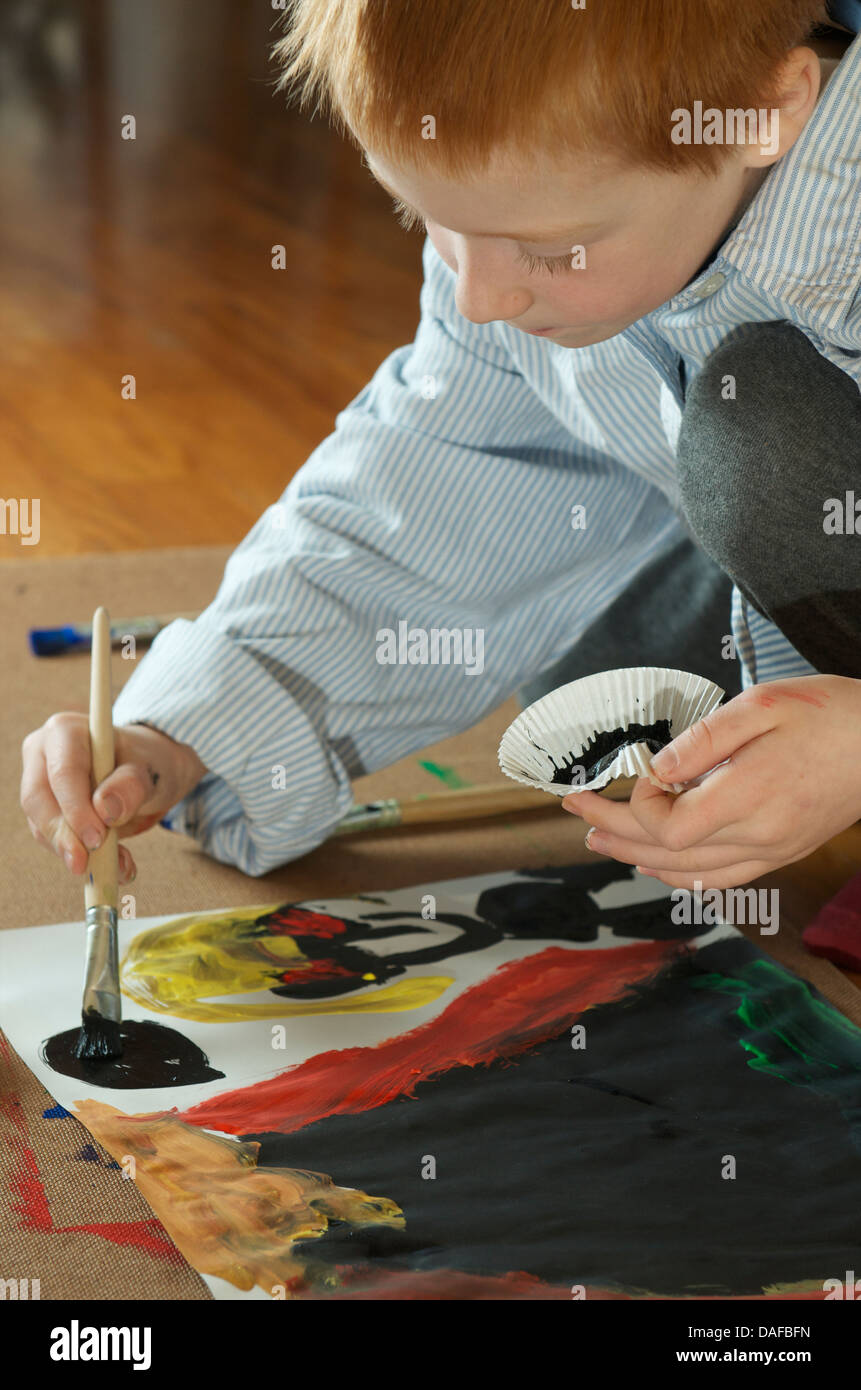 Germany, Baden Wuerttemberg, Constance, Boy painting on paper Stock ...