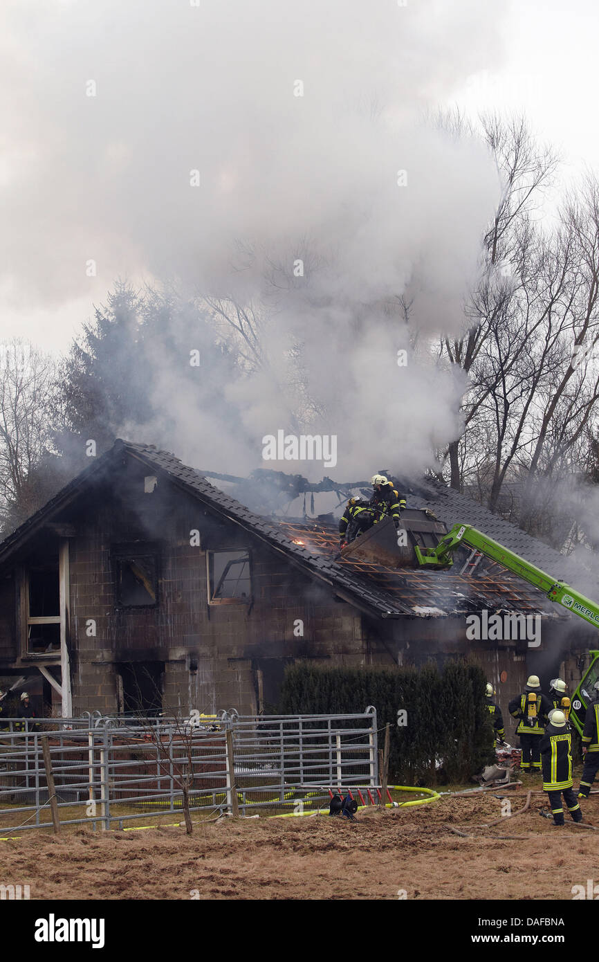 Firefighters extinguish the fire in a house in Rueckeroth, Germany, 18 ...