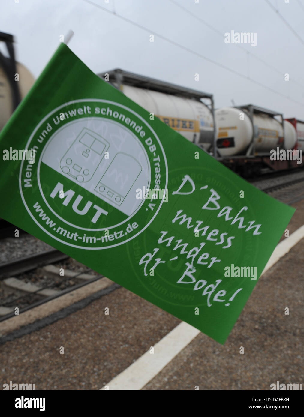 A freighttrain travels past the flag of a citizens' movement in ...