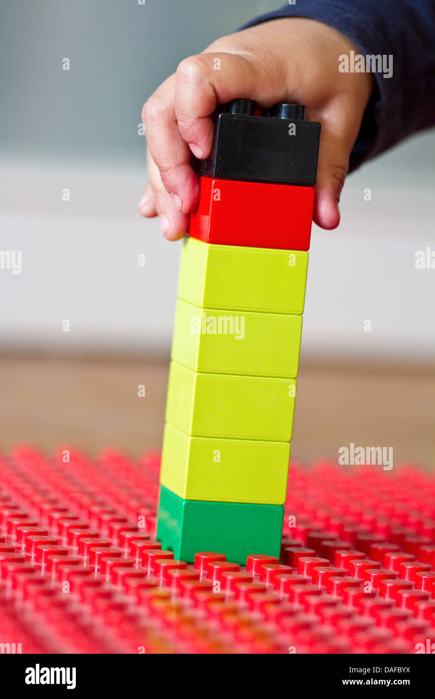 Human hand playing with lego bricks, close up Stock Photo - Alamy