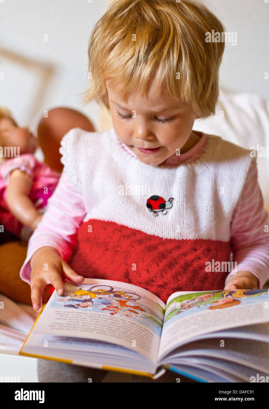 Girl looking at book, close up Stock Photo - Alamy