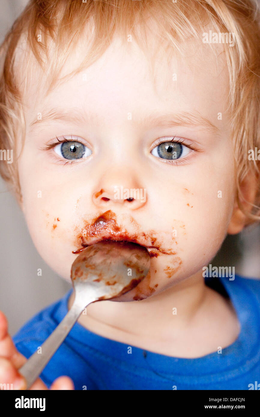 Girl nibbling chocolate with spoon hi-res stock photography and images ...