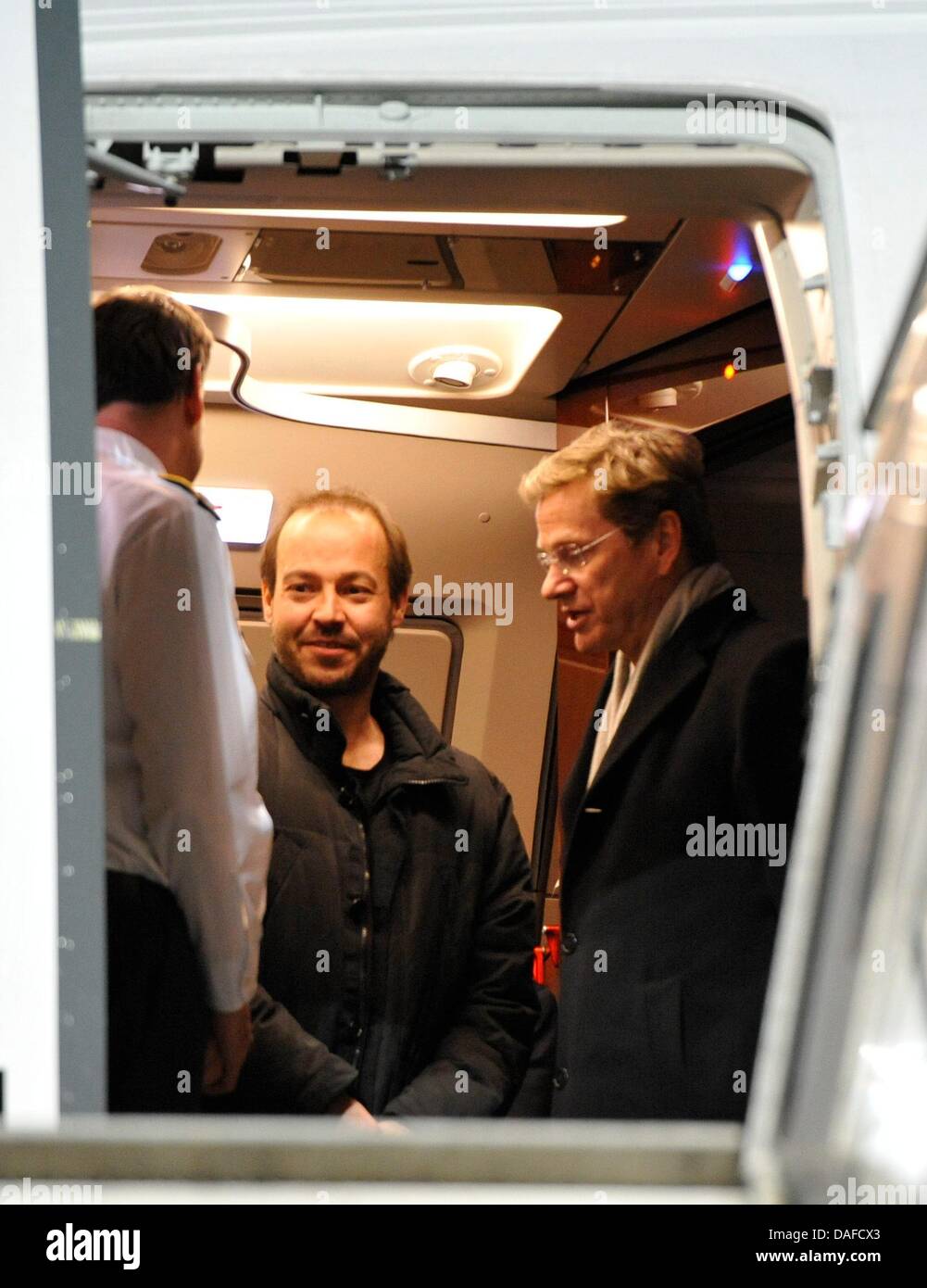 One of the two released German journalists, Marcus Hellwig (C), talks ...