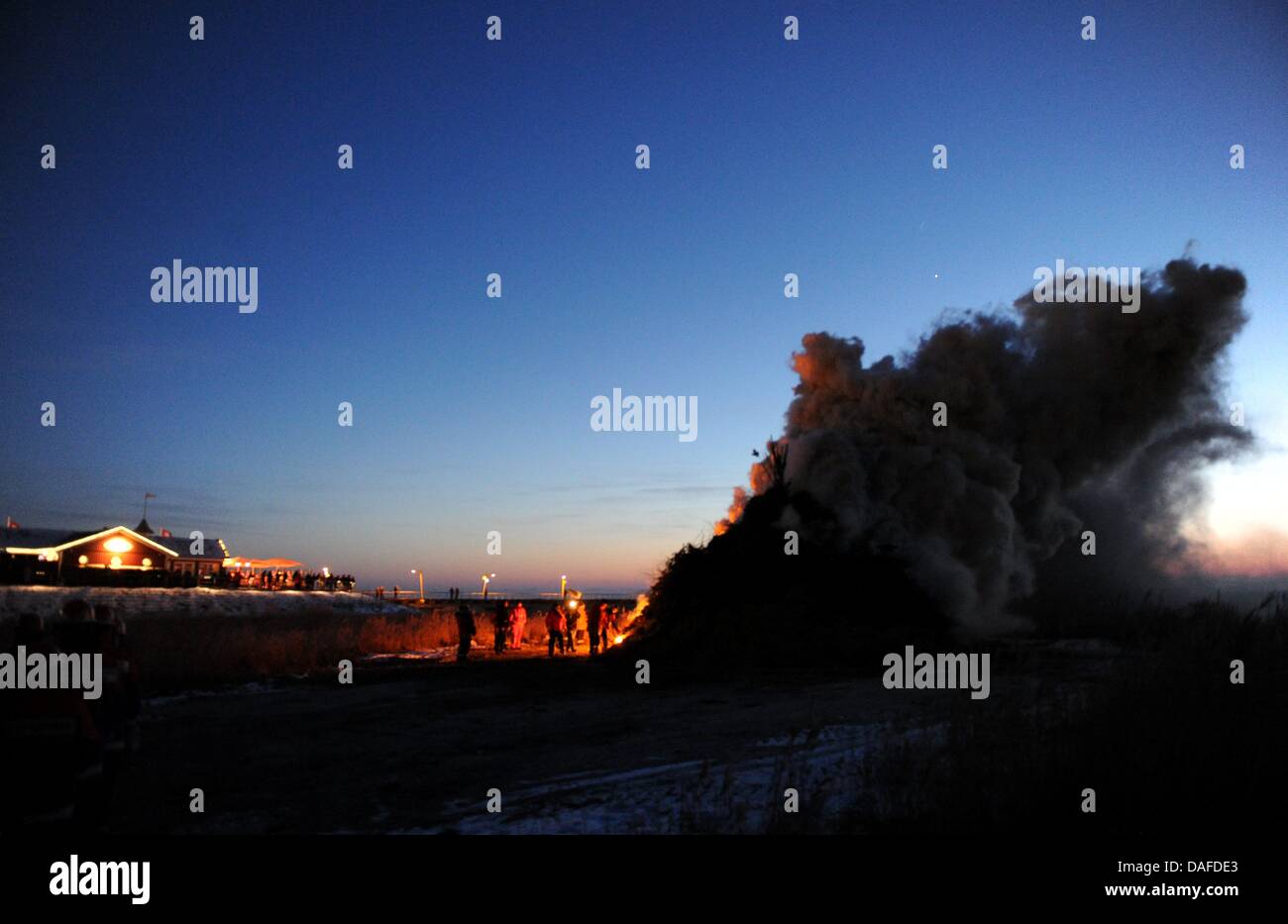 Visitors watch the traditional Biike fire in St.Peter-Ording, Germany ...