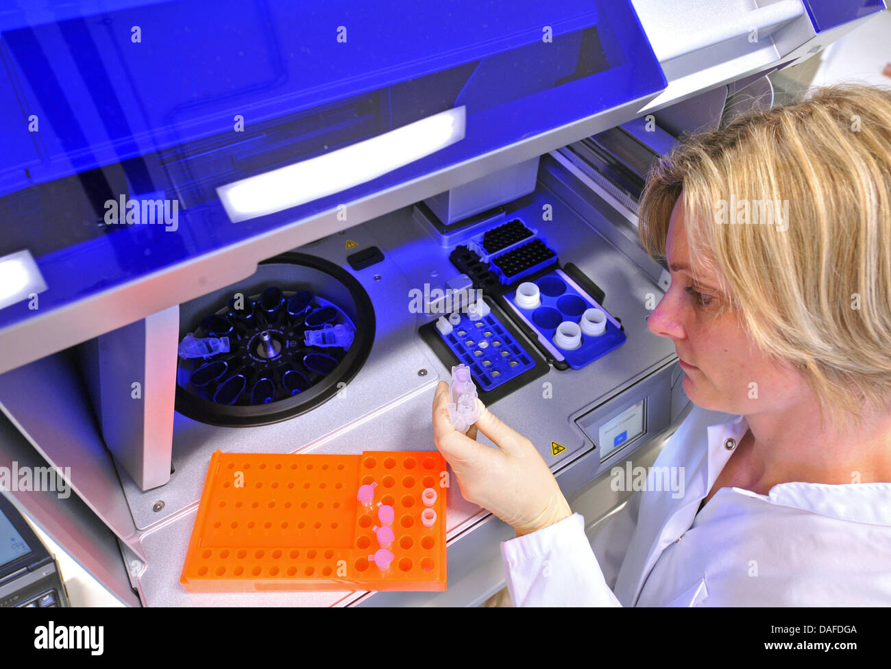Biochemist Jacqueline Maier simulates a test run of a DNA extraction ...