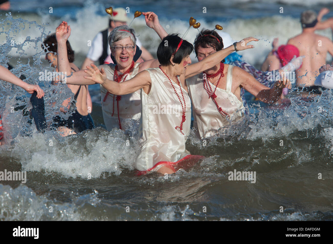 Men and women wearing old bathing suits take a bath at freezing ...