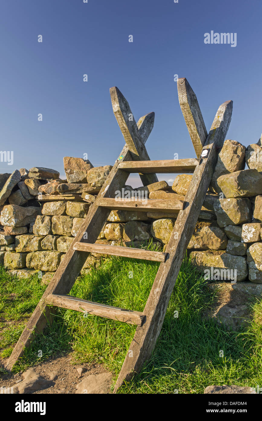 Stile over a dry-stone wall on Highshields Crags in the Northumberland ...