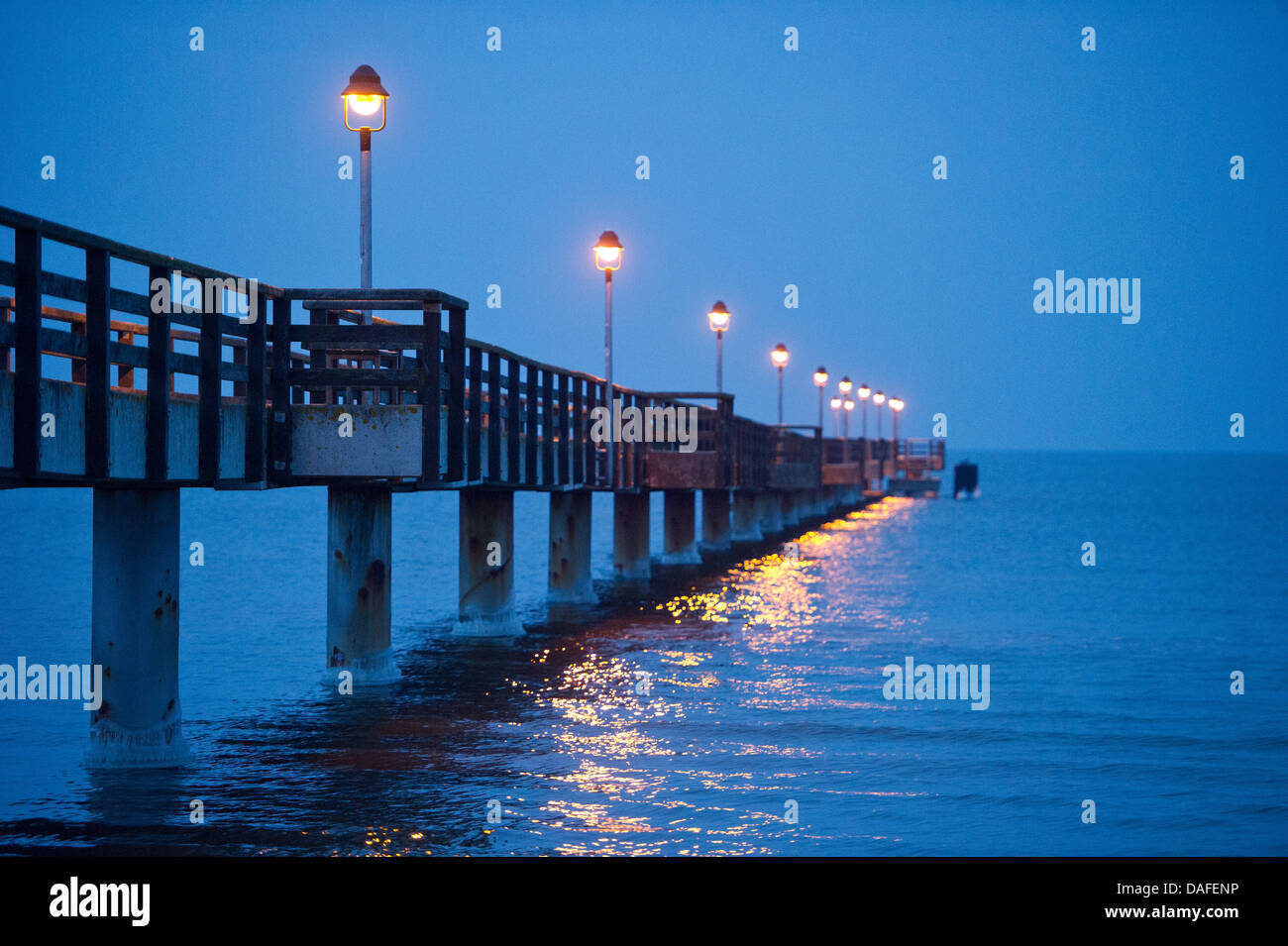 A pier at the beach of Lubmin is illuminated with blue light during the ...