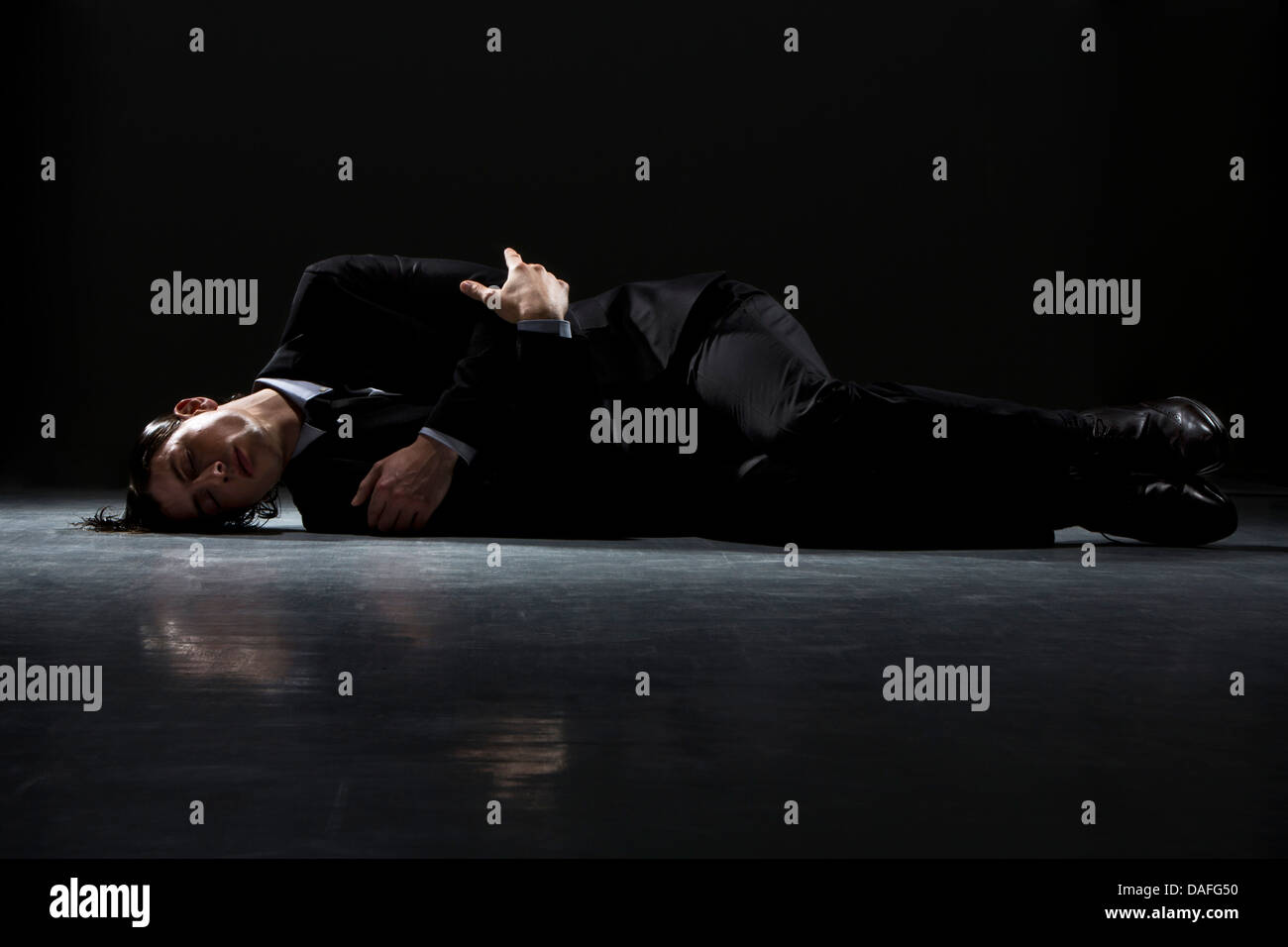 Actor lying down with arms crossed Stock Photo - Alamy