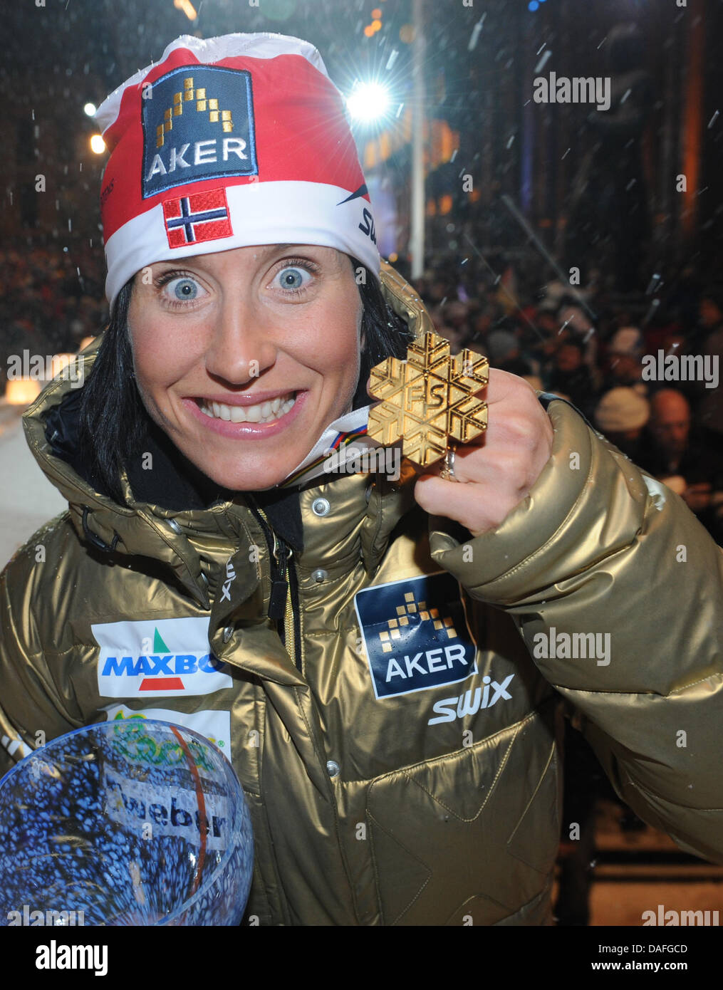 Cross Country gold medalist Marit Bjoergen of Norway shows her medal at ...