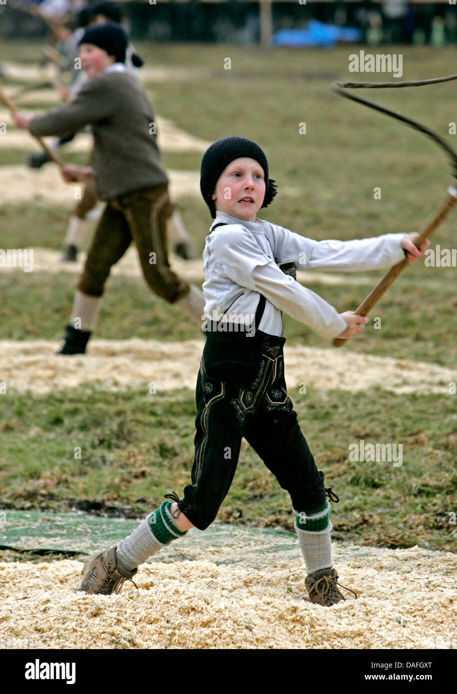 People in traditional Bavarian costumes take part in the whip challenge ...