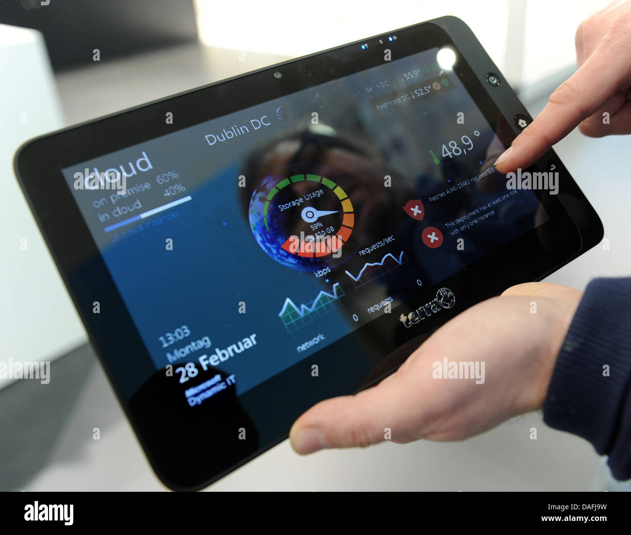 A man tries out the interface of Microsoft Germany's cloud application at the CeBIT information ...