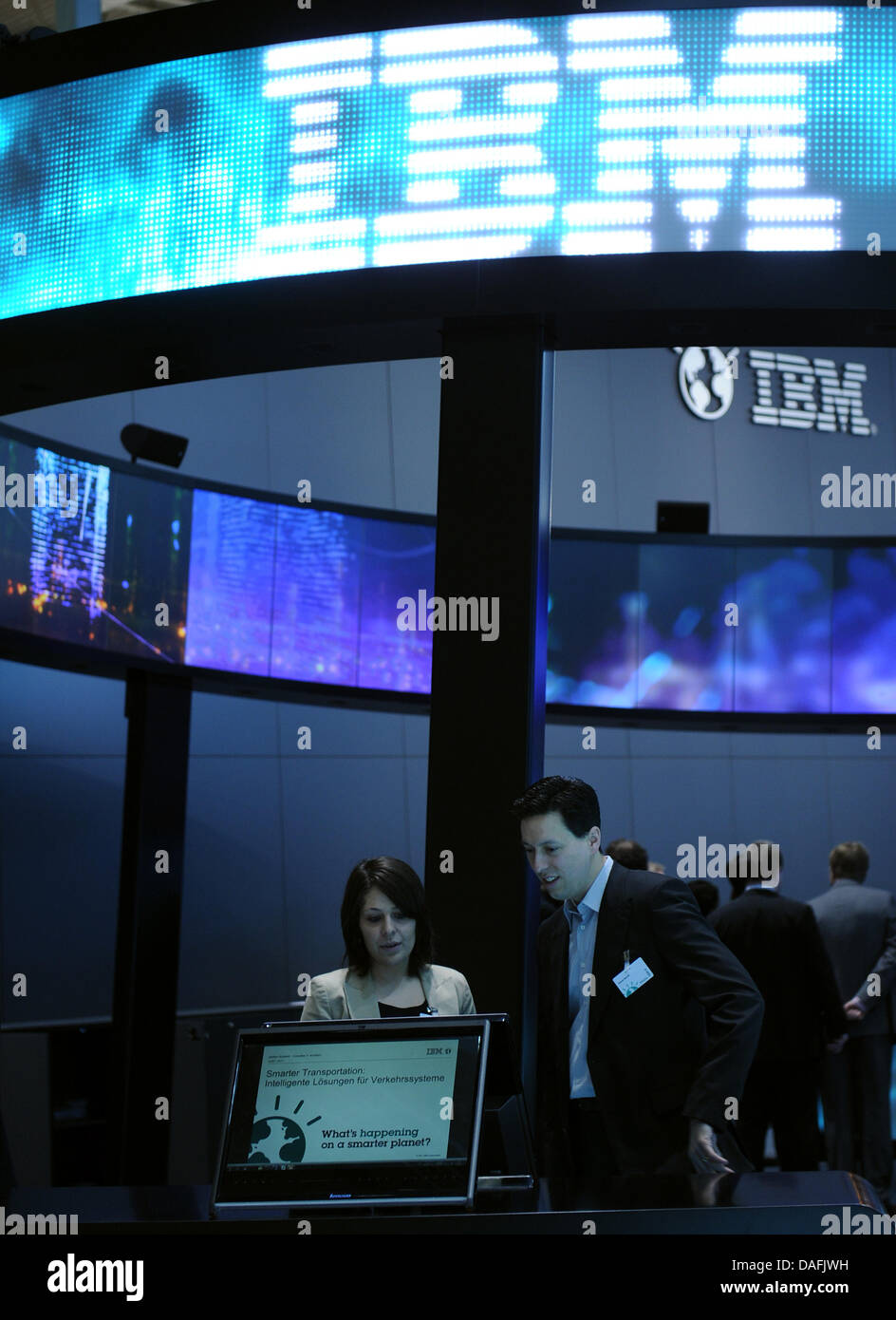 A couple stands at the IBM booth during the construction of the CeBIT ...