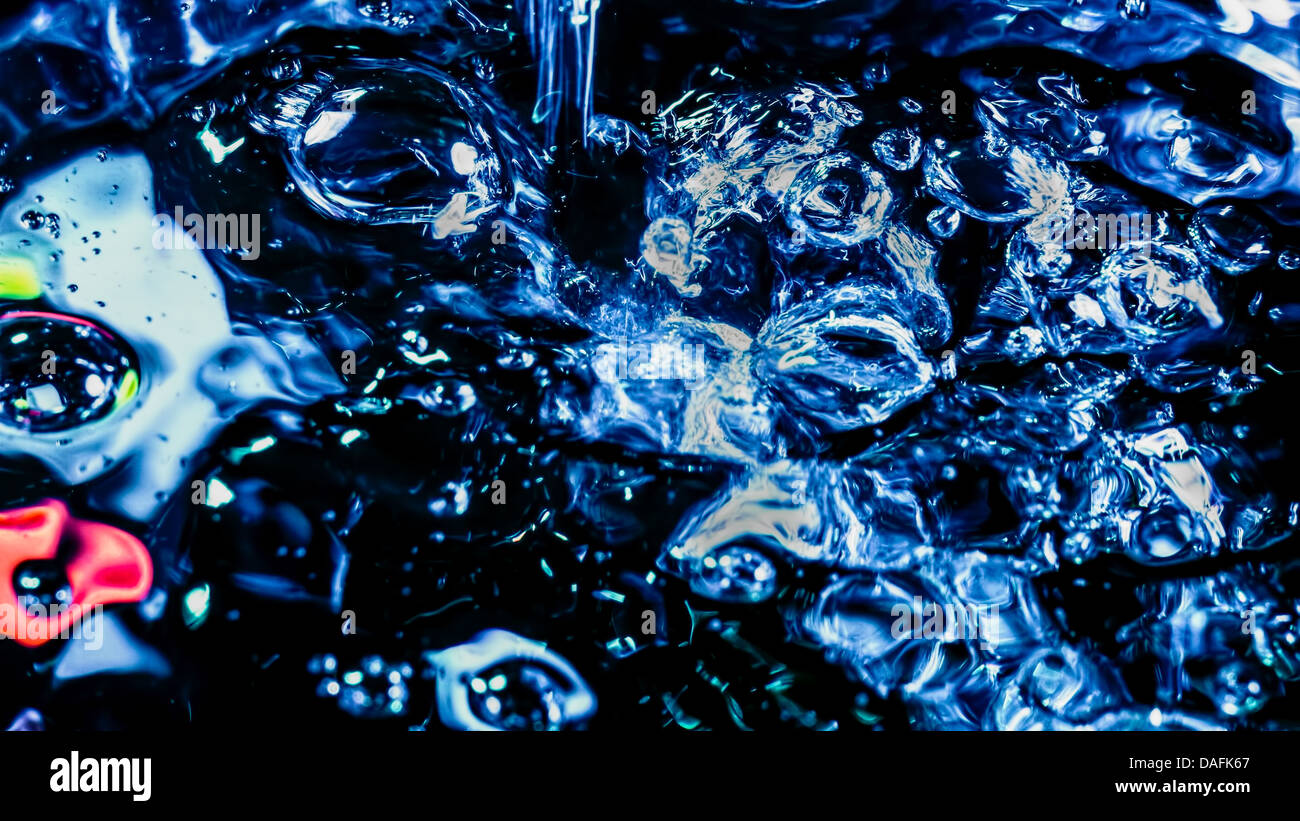 Fluid motion of splashing water and bubbles forming abstract alien ...