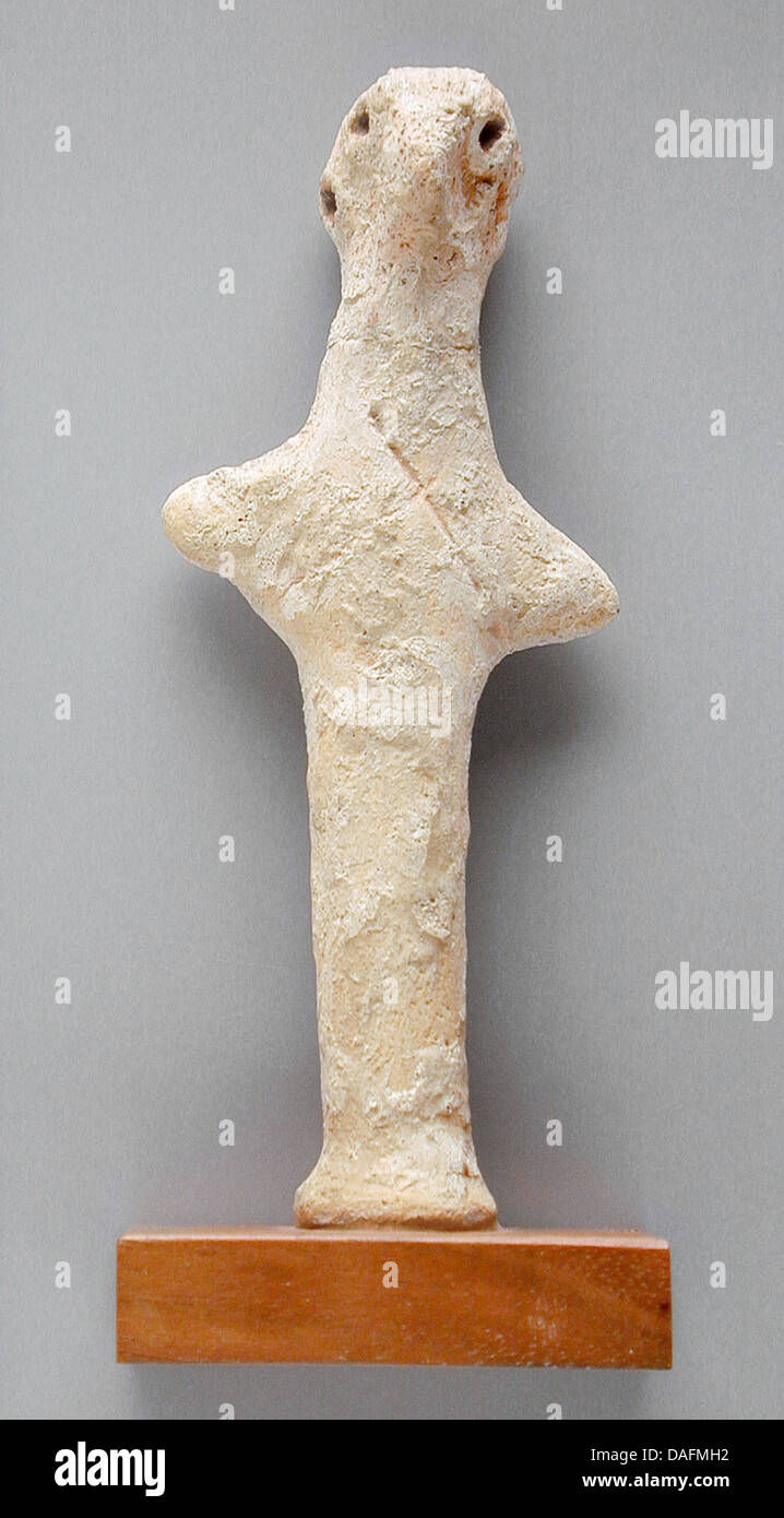 This figurine, carved with fine detail, represents an ancient figure in ...