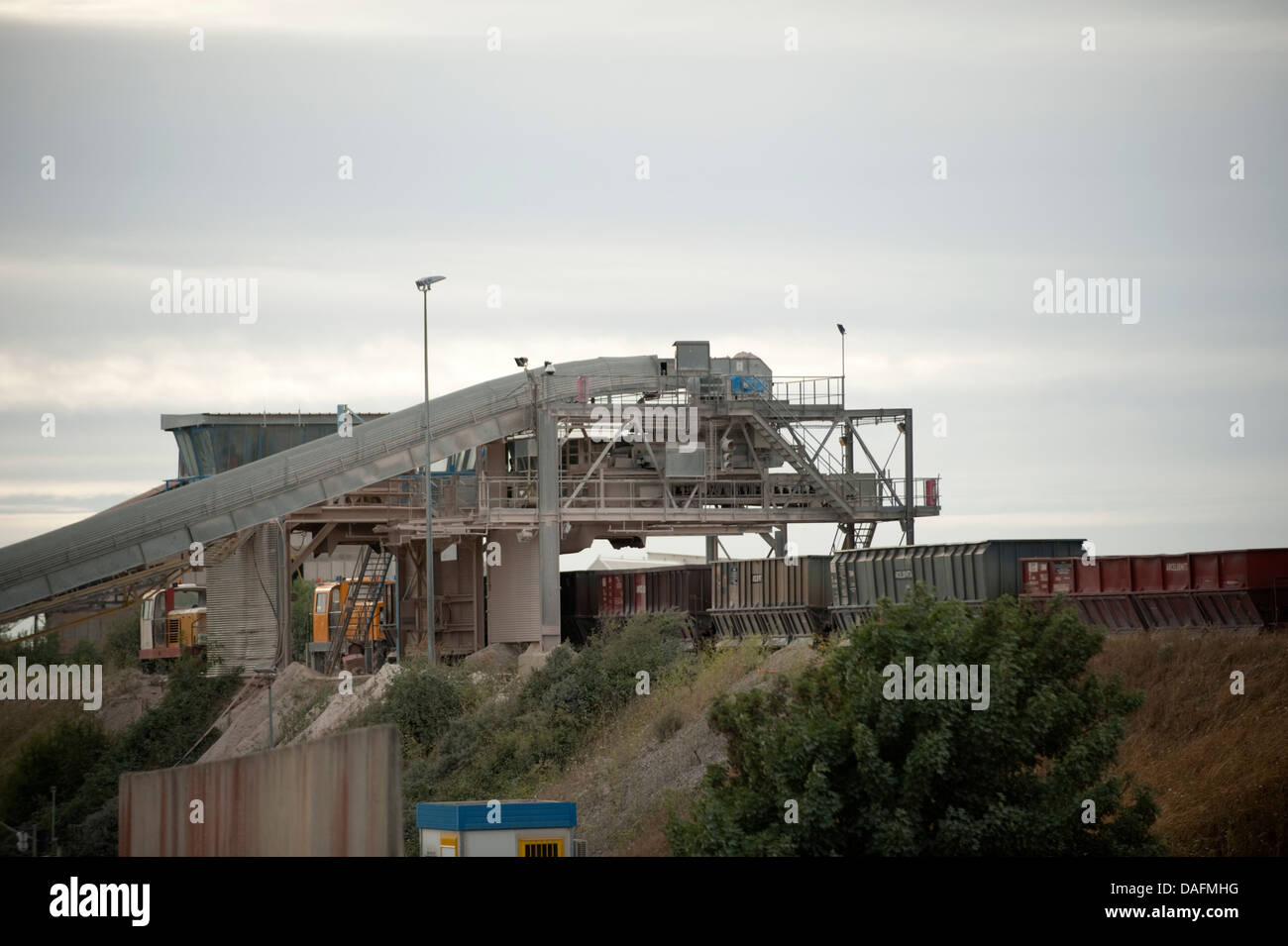 Quarry stone loading conveyor onto train France Stock Photo - Alamy