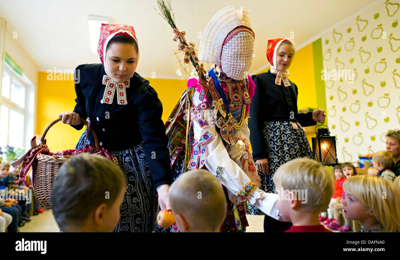 The traditionally dressed Sorbian Christkind with veiled face and ...