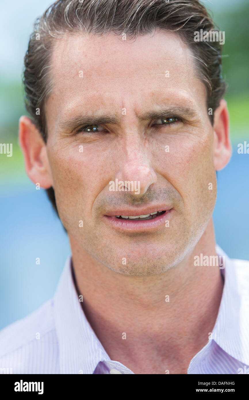 An outdoor portrait of handsome middle aged man shot with sunlight ...