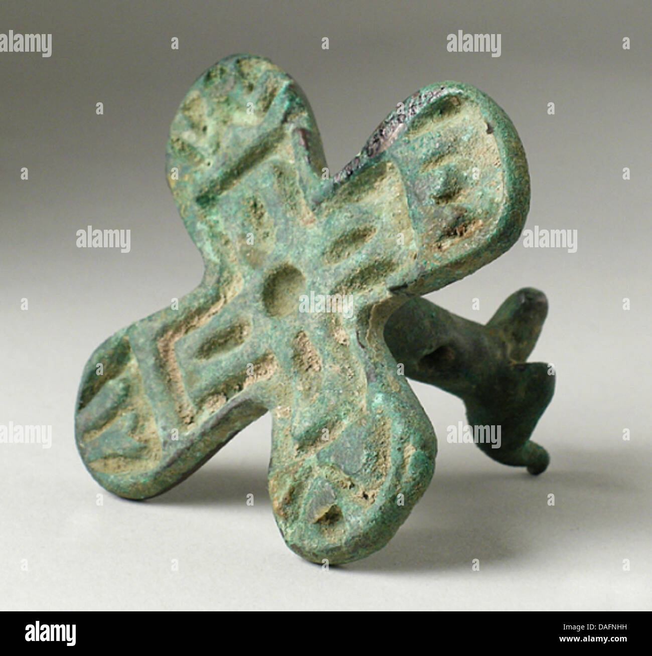 A set of four ancient stamp seals, each intricately carved with symbols ...