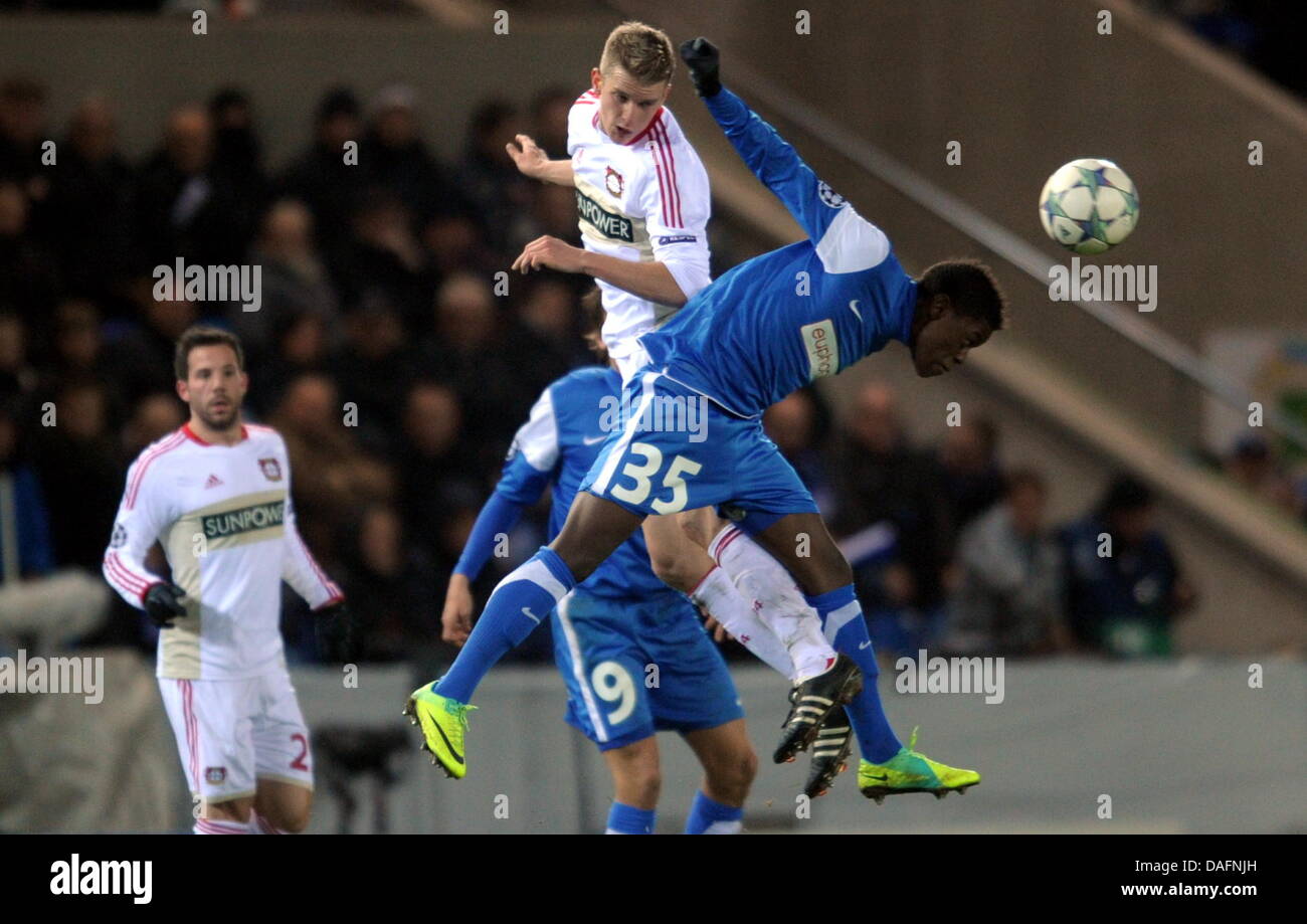 Leverkusen's Lars Bender (top) and Genk's Anthony Limbombe (R) vie for ...